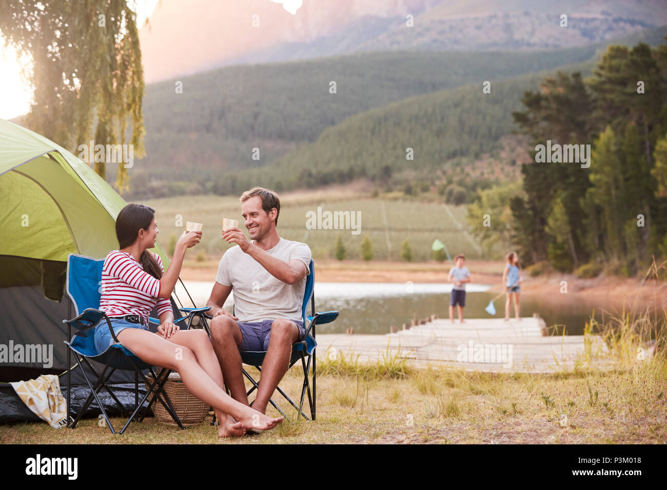 Family Enjoying Camping Vacation By Lake Together Stock Photo - Alamy