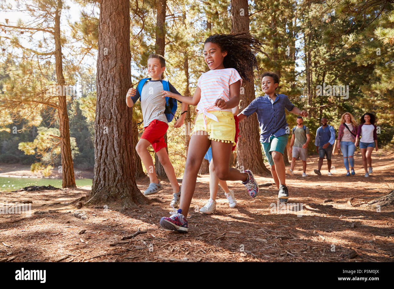 Children Running Ahead Of Parents On Family Hiking Adventure Stock ...
