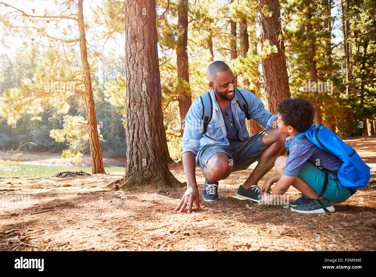 Father And Son On Hiking Adventure In Woods By Lake Stock Photo - Alamy