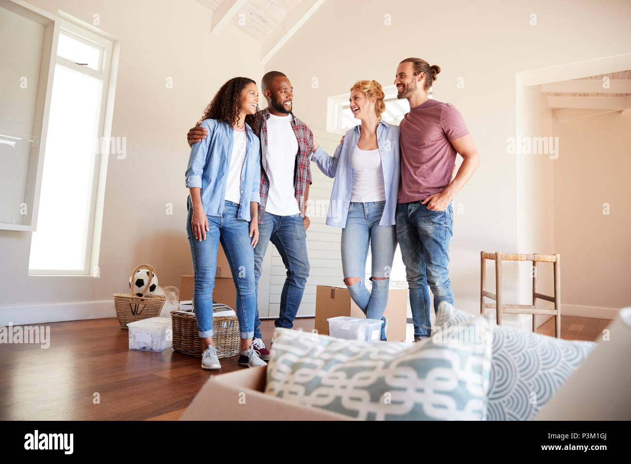 Friends Helping Couple To Move Into New Home Stock Photo - Alamy