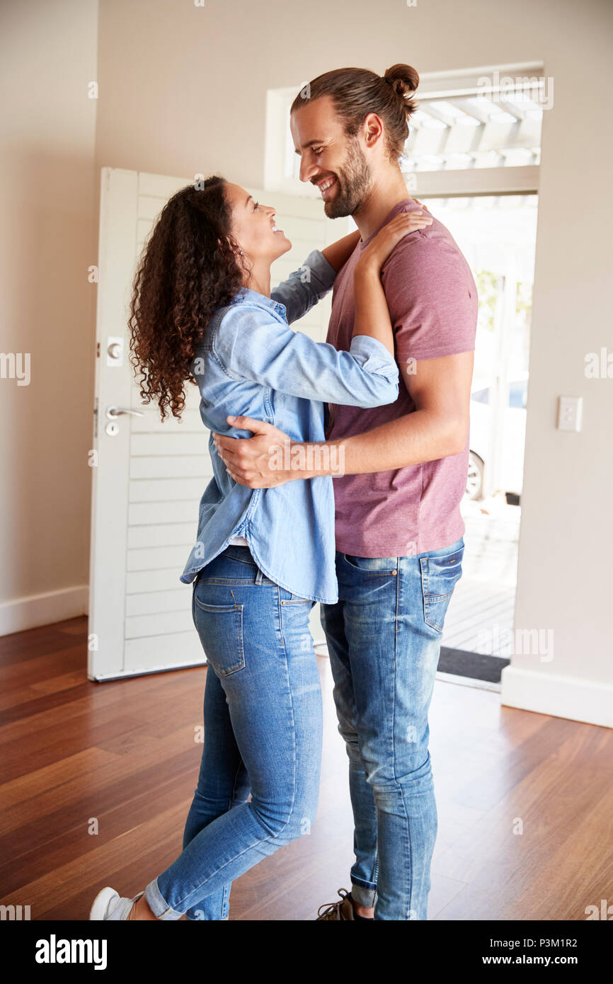 Couple hugging front door hi-res stock photography and images - Alamy