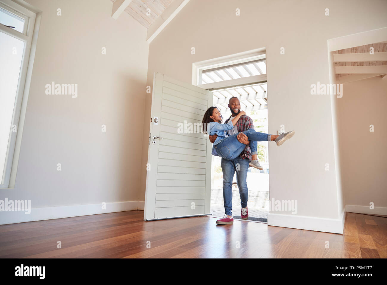 Man Carrying Woman Over Threshold Of Doorway In New Home Stock Photo ...