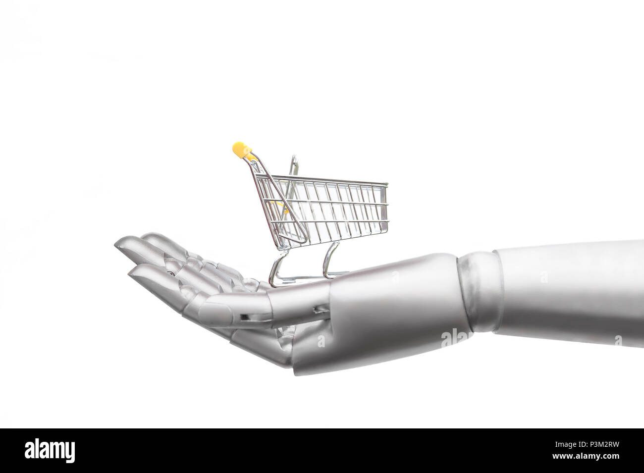 A robotic arm holds an empty shopping cart. Isolated in front of white ...