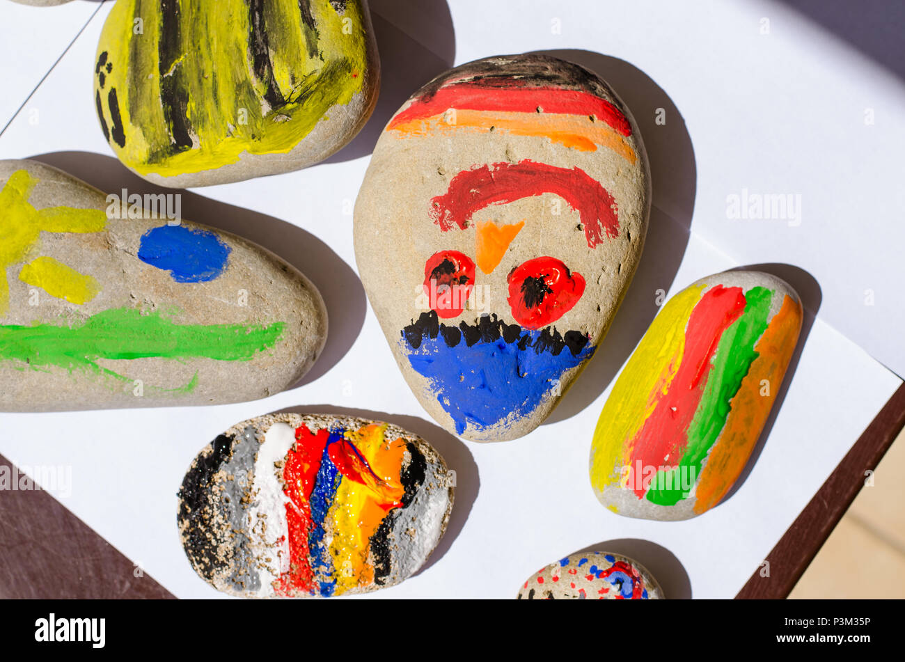 group of pebbles with bright paintings and colors Stock Photo - Alamy