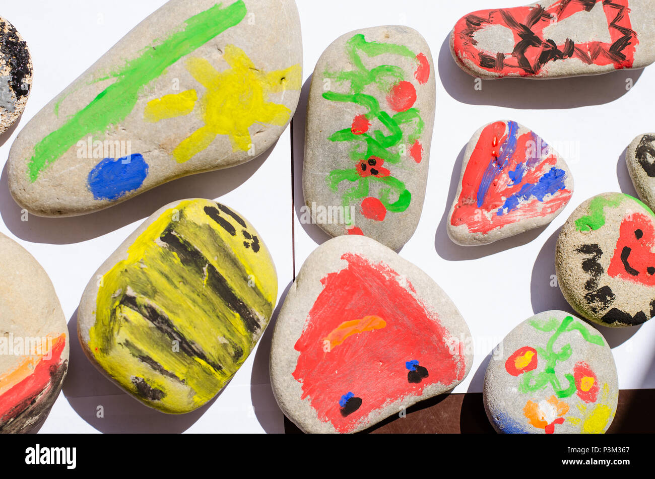 group of pebbles with bright paintings and colors Stock Photo - Alamy