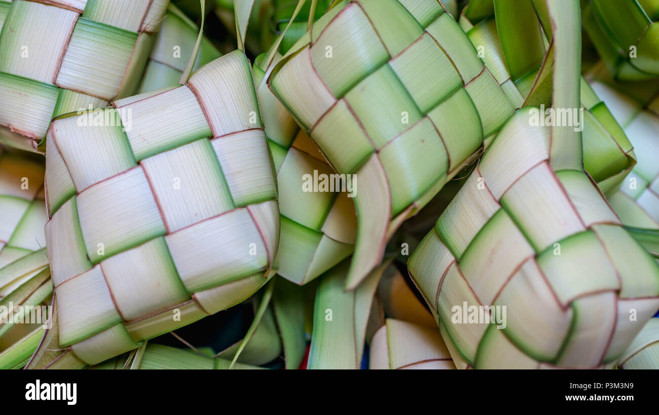 "Ketupat": steamed rice wrapped with woven young palm leaf. traditional ...