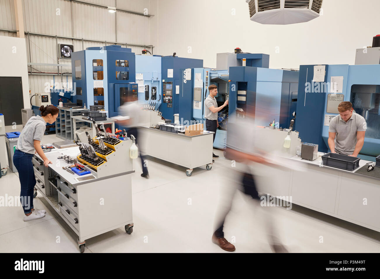 Busy Engineering Workshop With Workers Using CNC Machinery Stock Photo ...