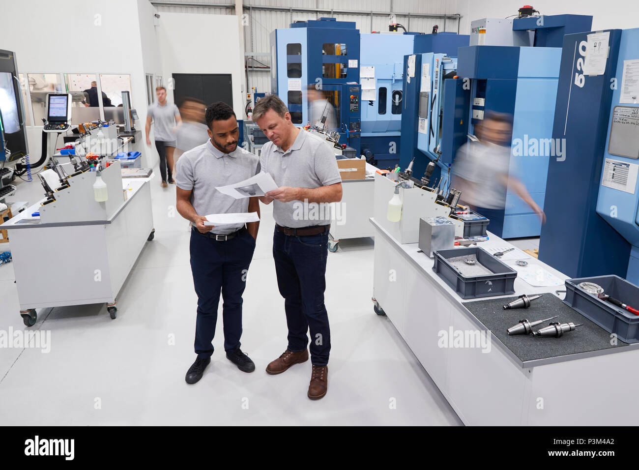 Engineers Meeting On Factory Floor Of Busy Engineering Workshop Stock ...