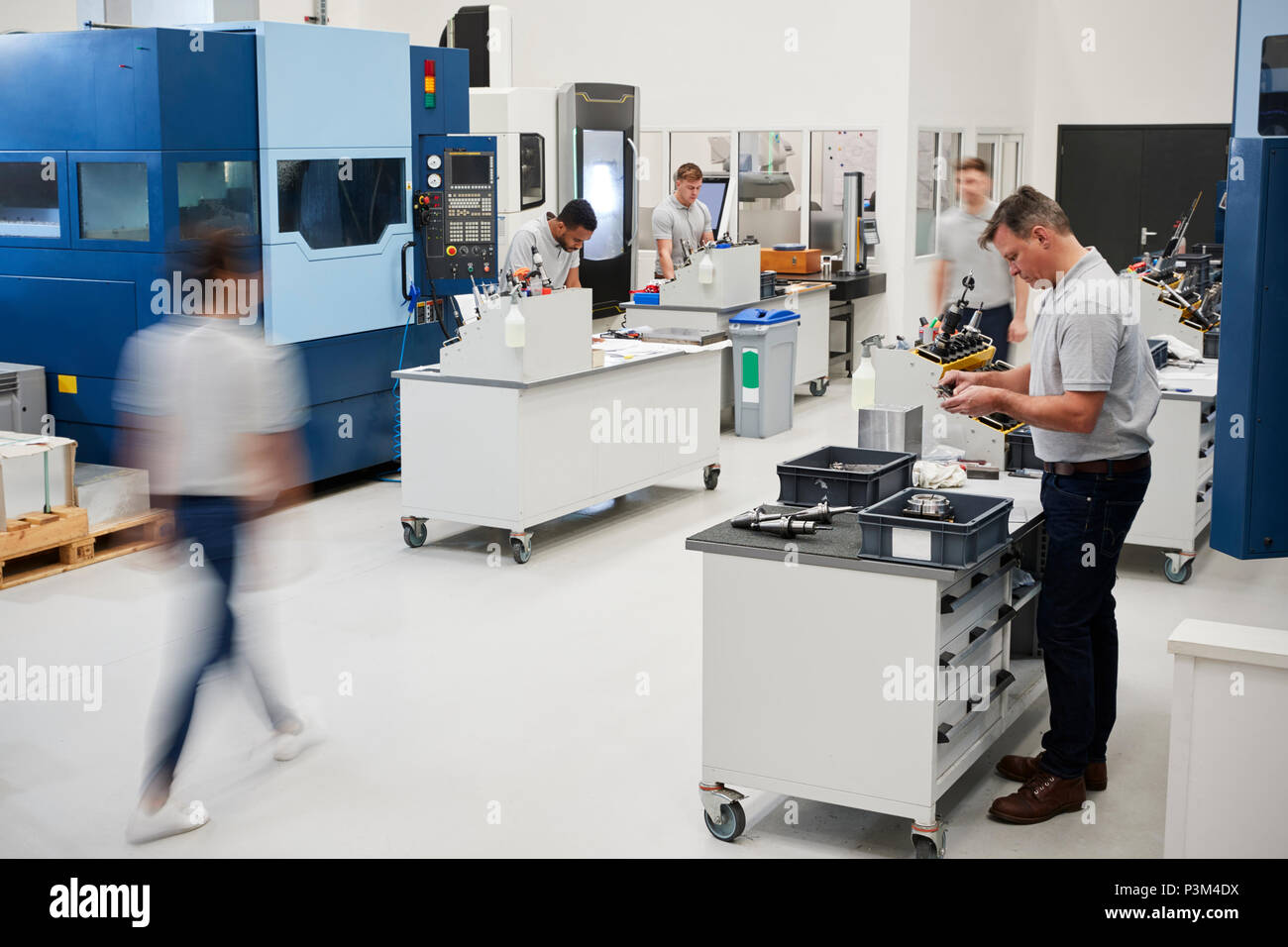 Busy Engineering Workshop With Workers Using CNC Machinery Stock Photo ...