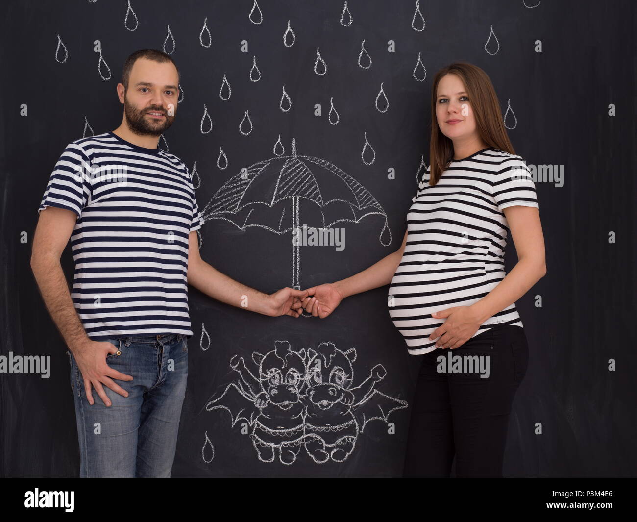 Conceptual photo of pregnant couple drawing their imaginations about ...