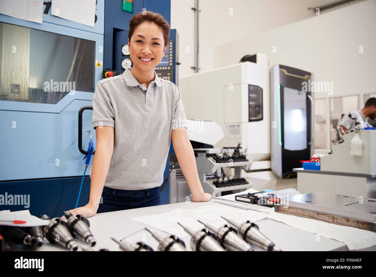 Portrait Of Female Engineer With CAD Drawings In Factory Stock Photo ...