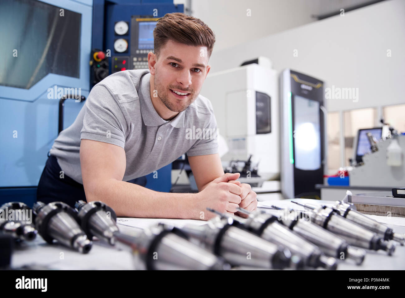 Portrait Of Male Engineer With CAD Drawings In Factory Stock Photo - Alamy