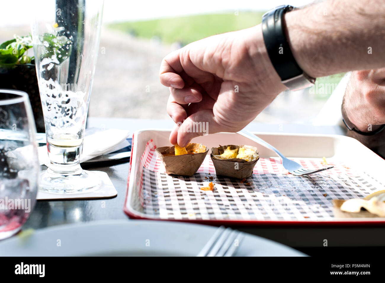 the man is eating fast food in a cafe. A table by the window. Empty ...
