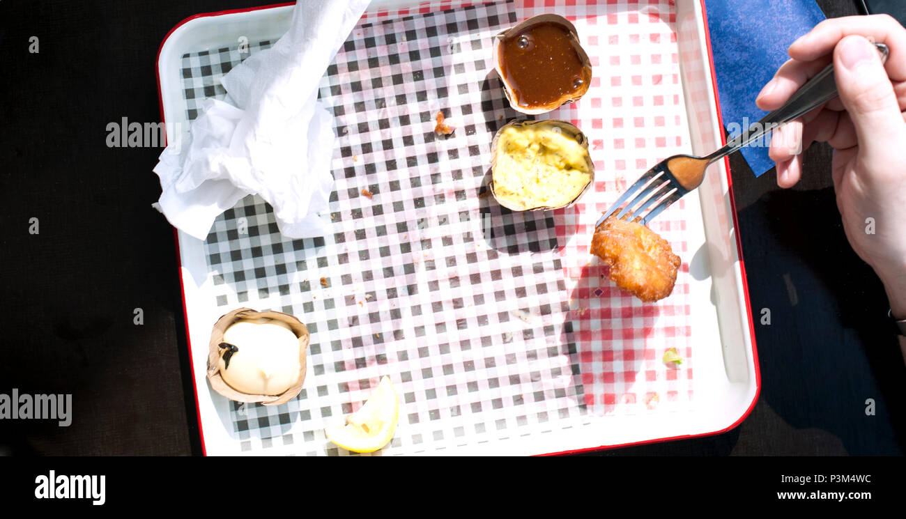 the man is eating fast food in a cafe. A table by the window. Empty ...