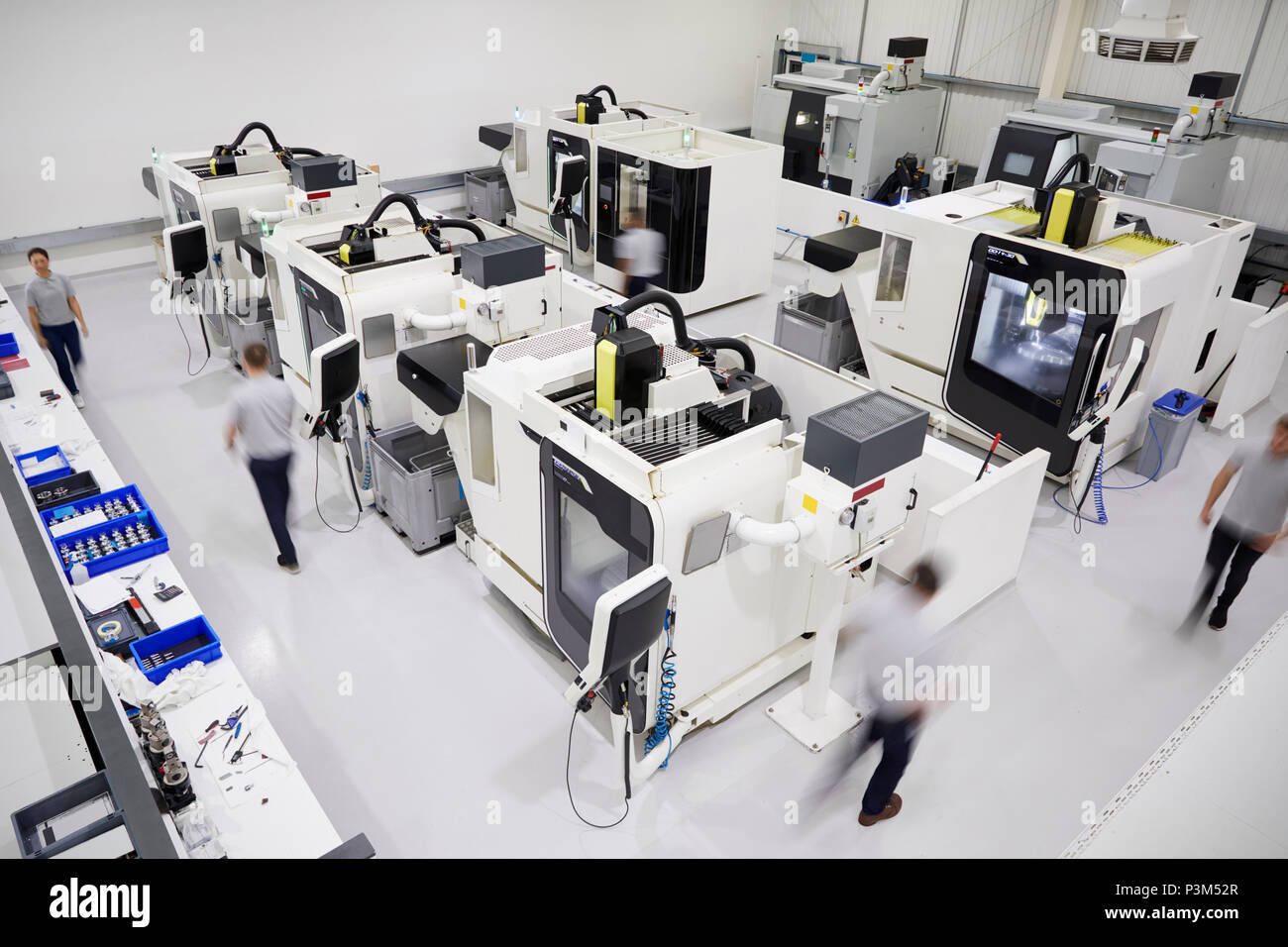 Overhead View Of Engineering Workshop With Workers Using CNC Machinery ...