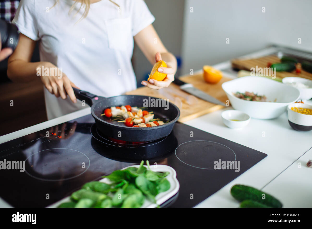Young woman cooking frying chicken hi-res stock photography and images ...