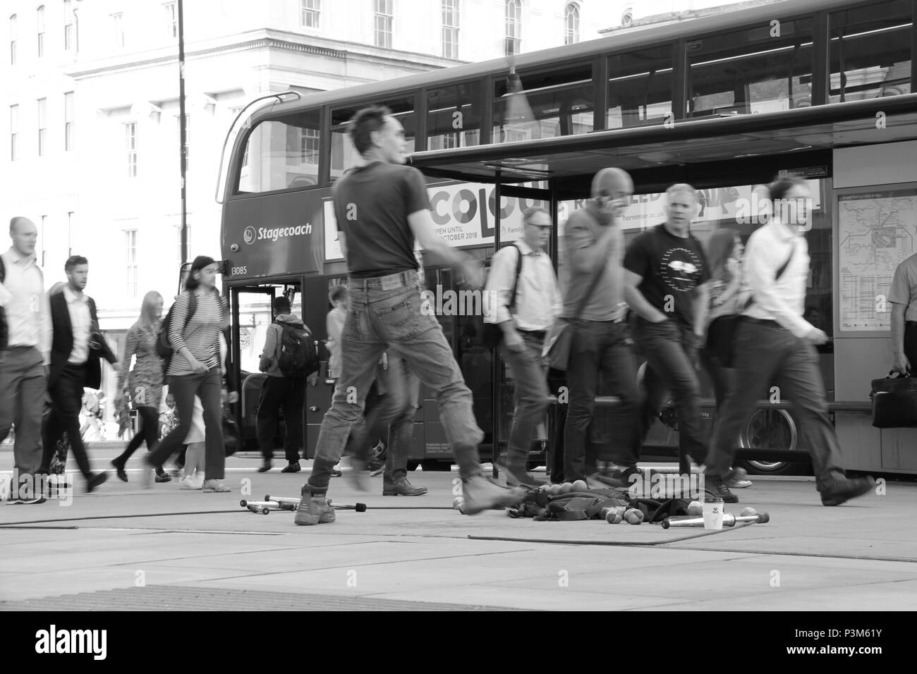 Juggler attempting to entertain commuters and office workers on London ...