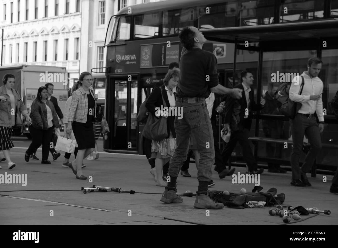 Juggler attempting to entertain commuters and office workers on London ...