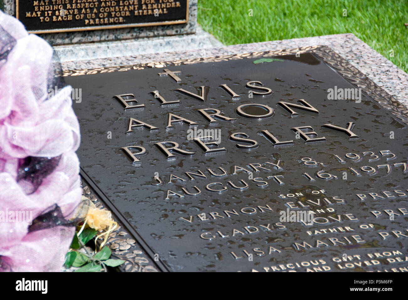 Elvis Presley’s grave, surrounded by flowers and tributes on the 40th ...
