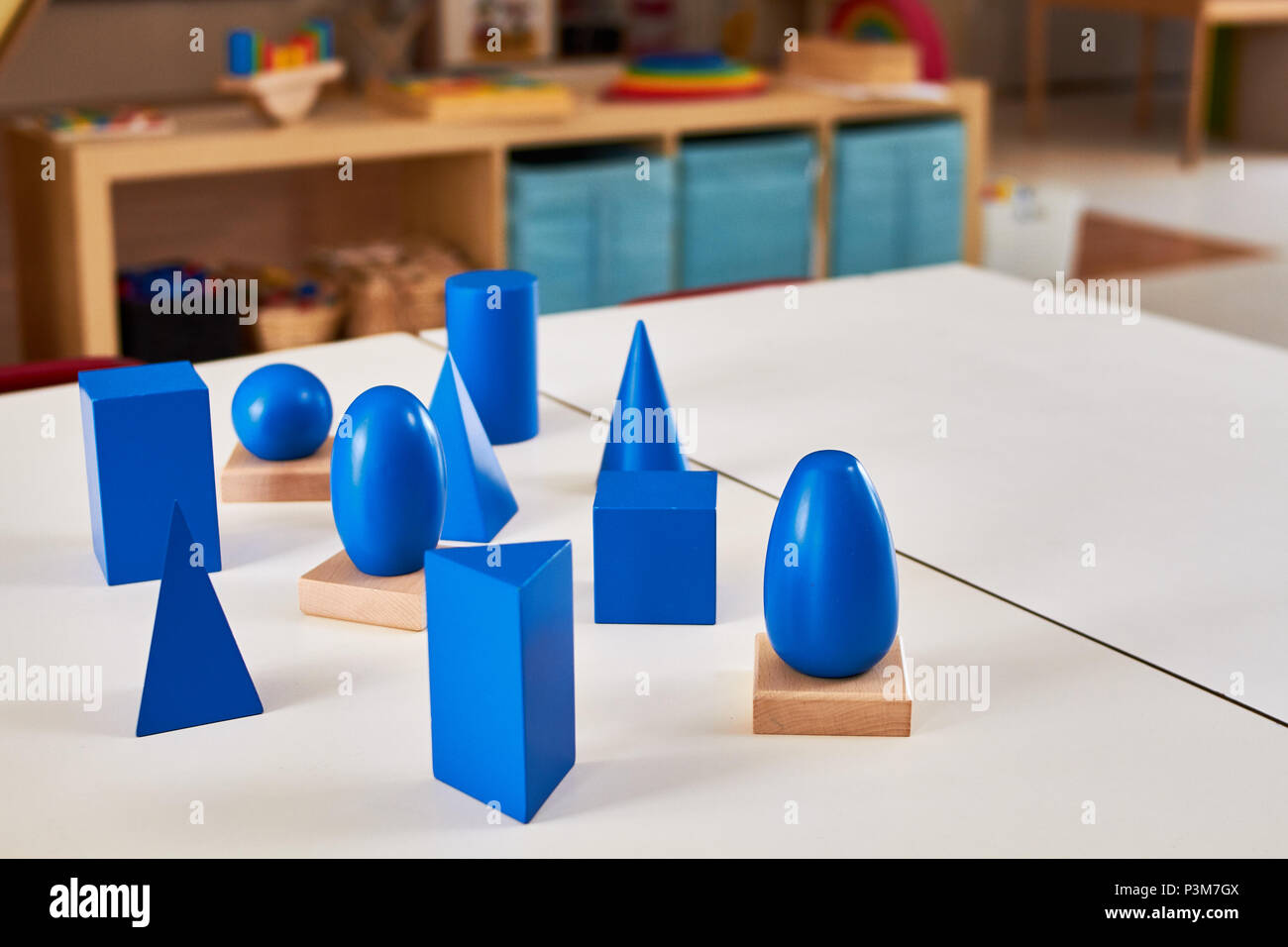 Wood Montessori geometrical blue solid volume set Stock Photo - Alamy
