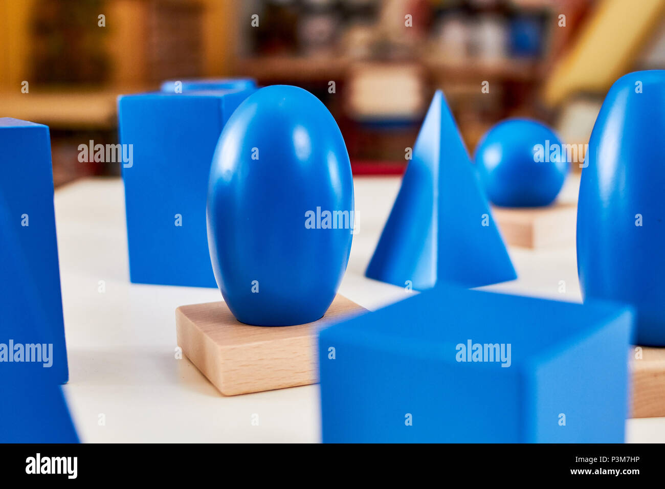 Wood Montessori geometrical blue solid volume set Stock Photo - Alamy