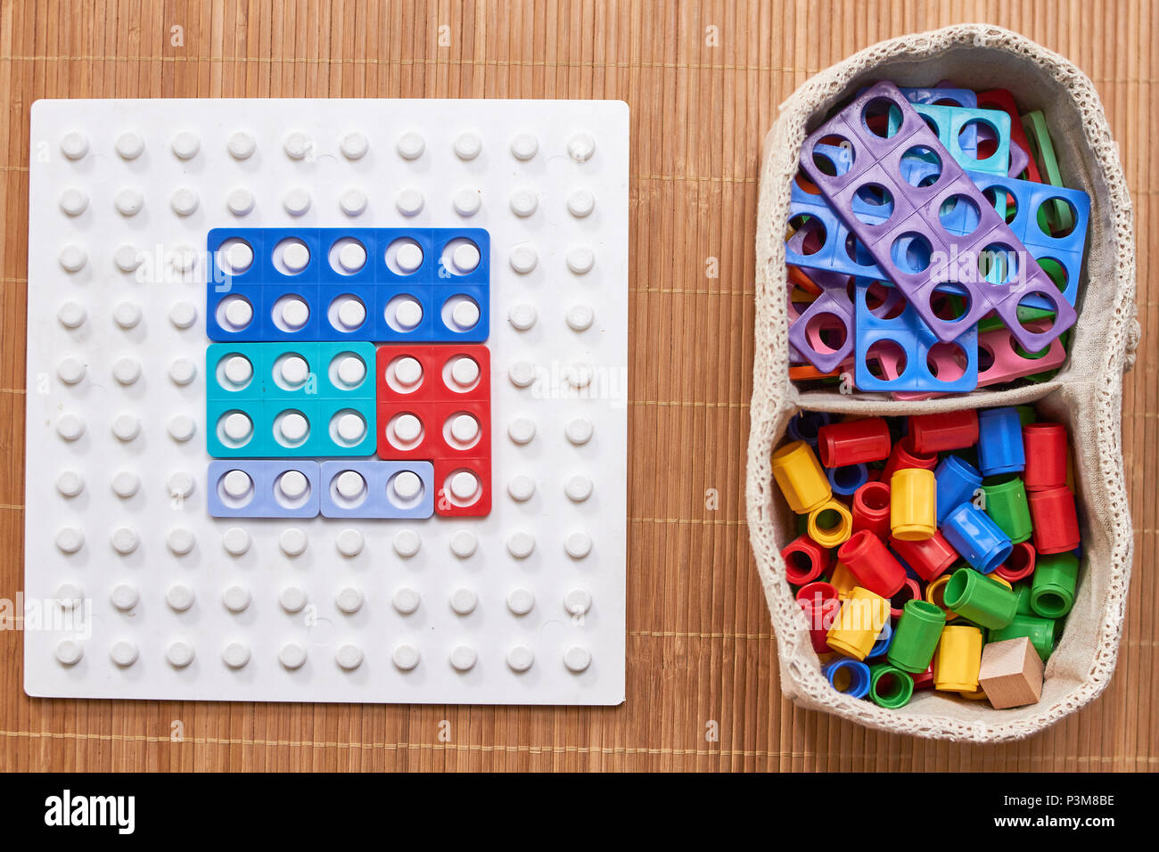 Colorful numicon game set with basket full of pieces Stock Photo - Alamy
