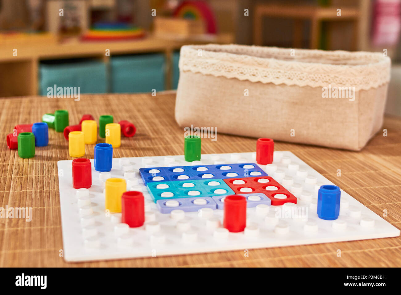 Colorful numicon game set with basket full of pieces Stock Photo - Alamy