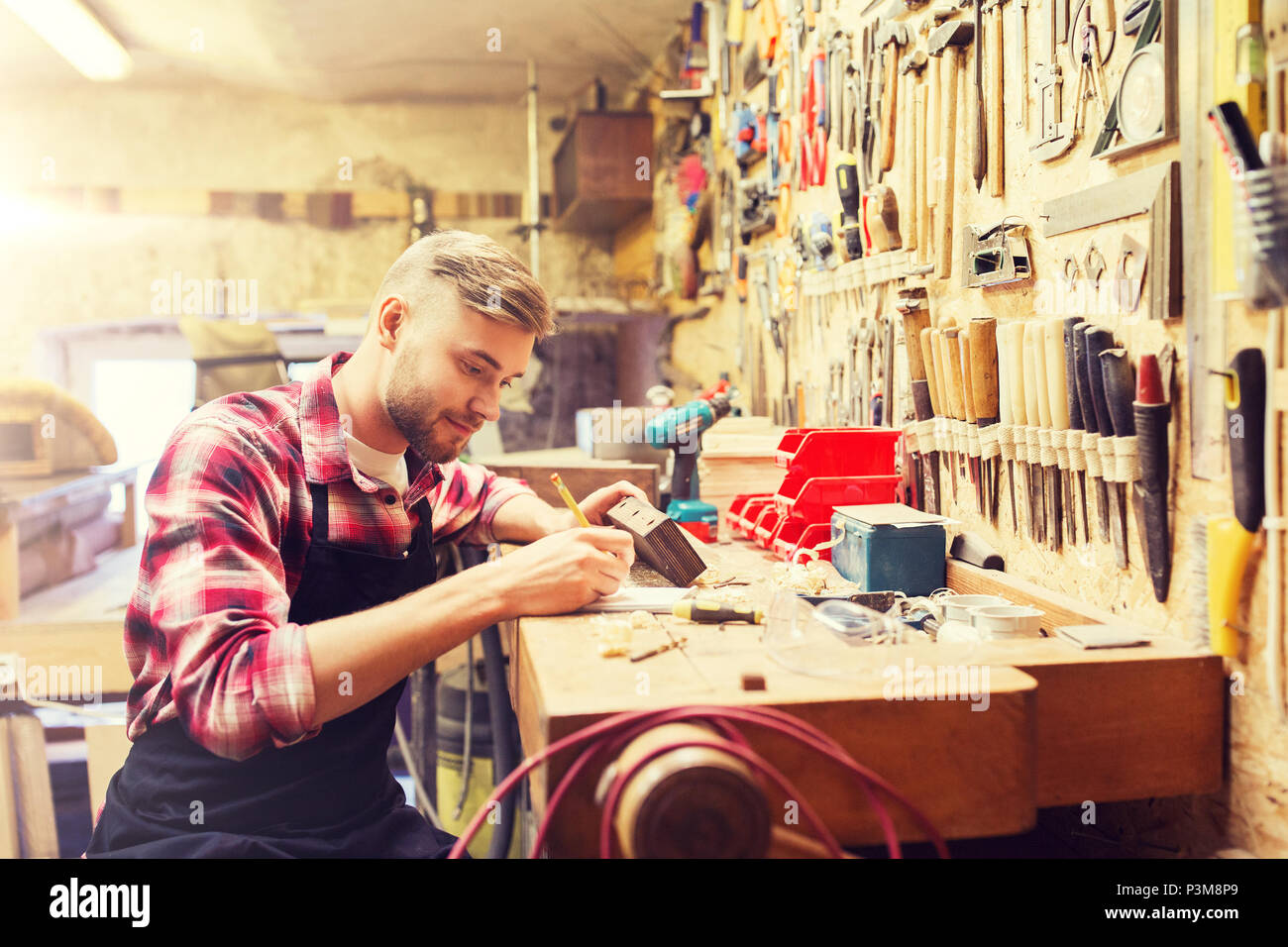 carpenter working with wood plank at workshop Stock Photo - Alamy