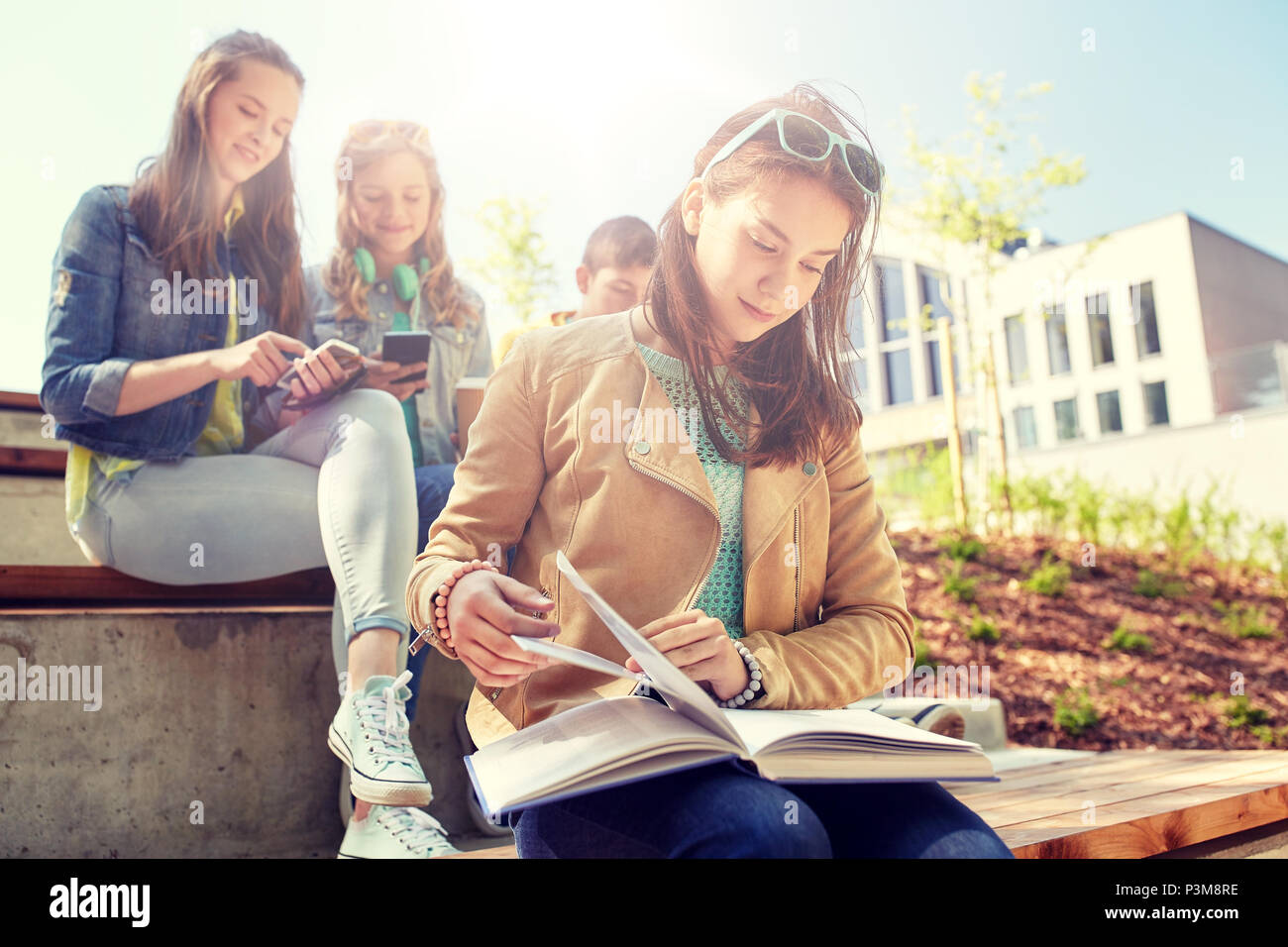 high school student girl reading book outdoors Stock Photo - Alamy