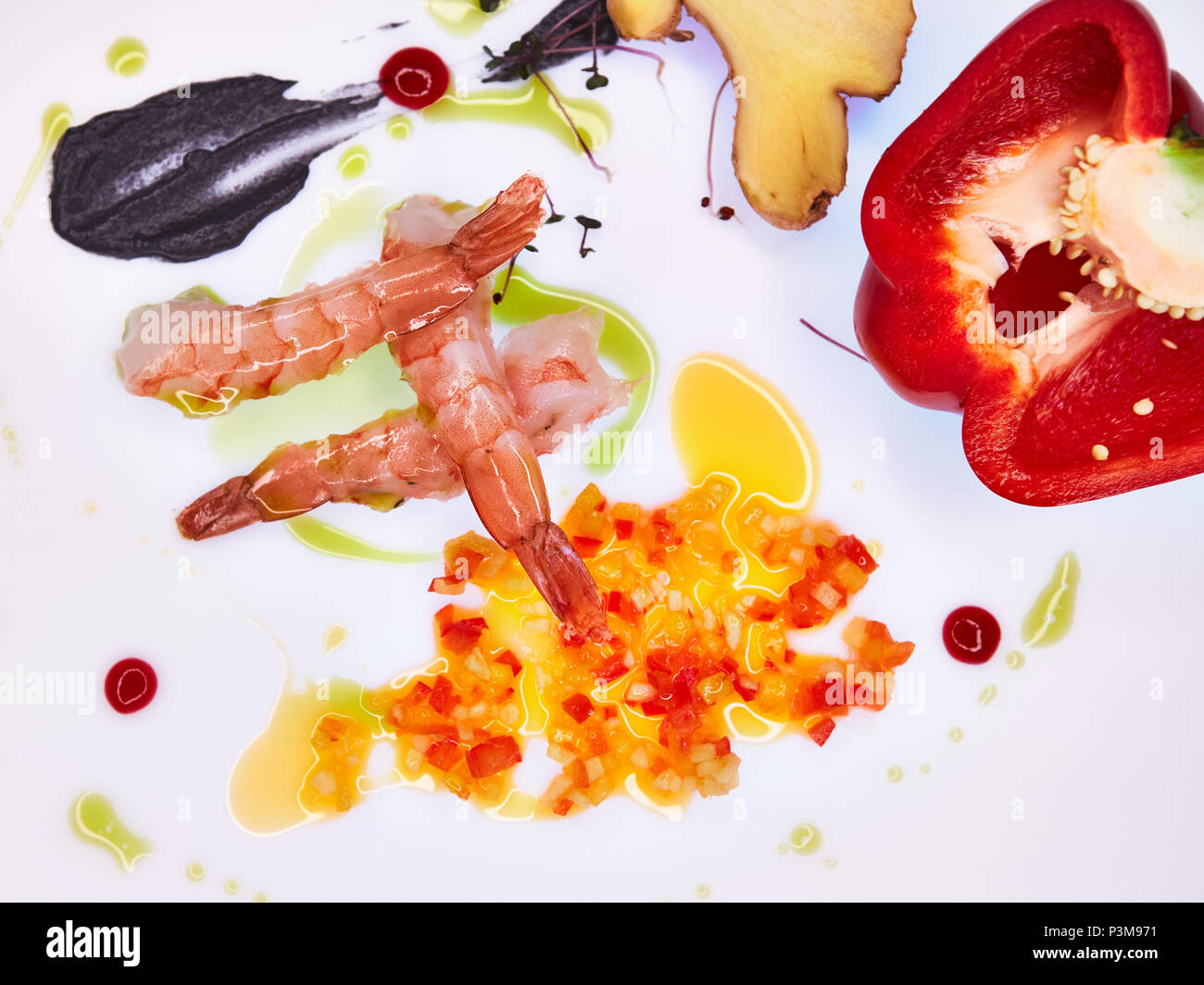 three prawns on a white table decorated with chopped vegetables and ...