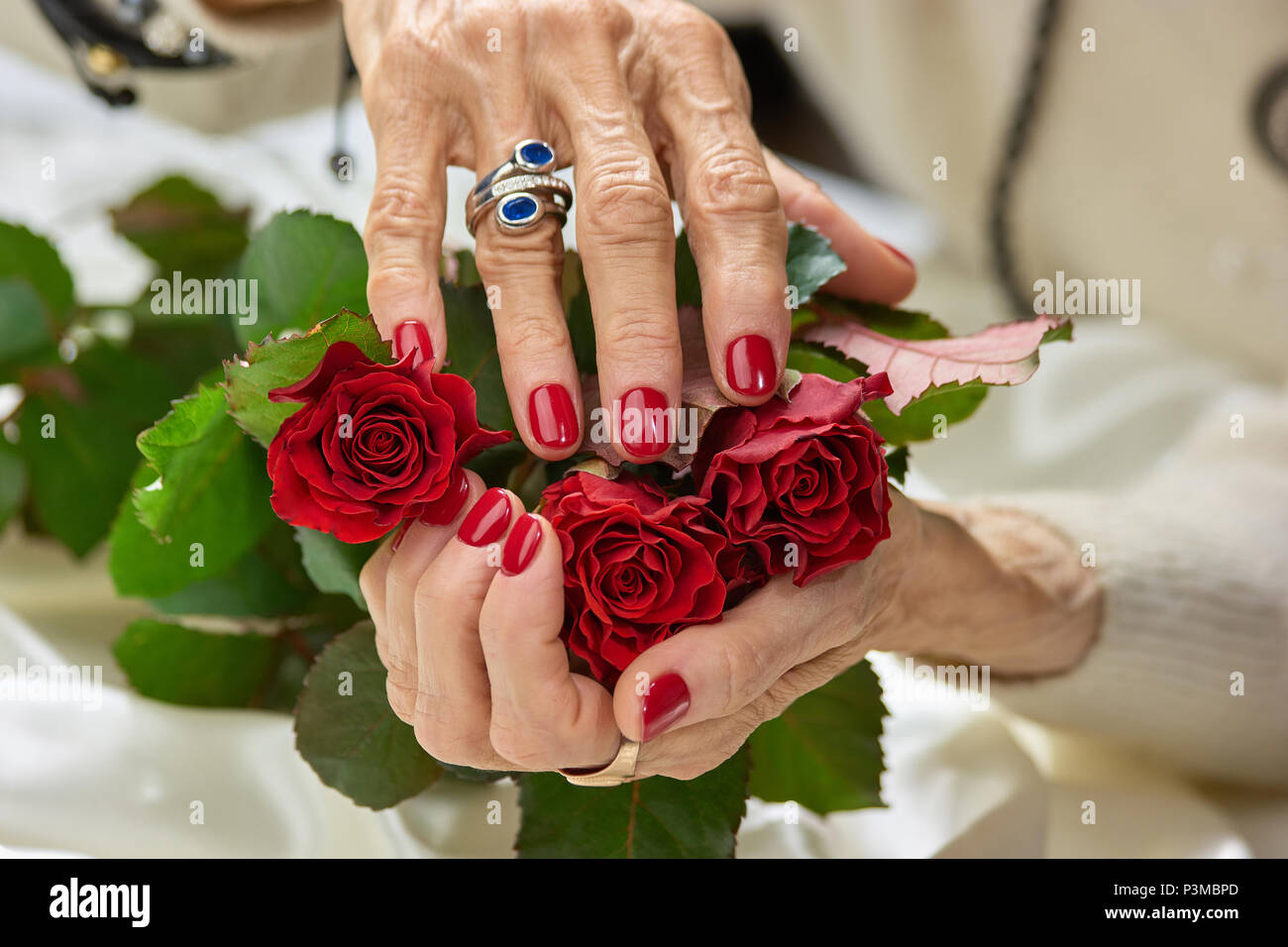 Luxury roses in manicured hands hi-res stock photography and images - Alamy