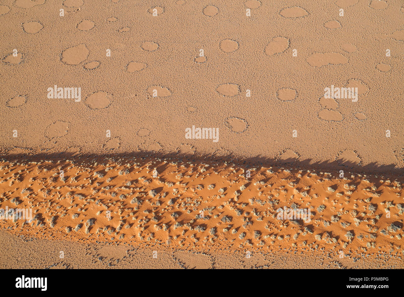 Aerial dune with fairy circles on either side in landscape from tourist ...