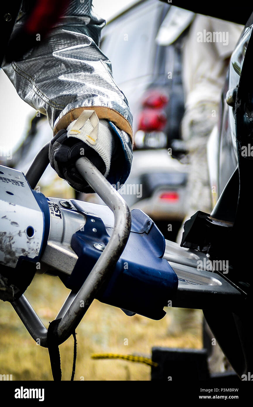 A firefighter from the 2nd Civil Engineers Squadron uses a spreader ...