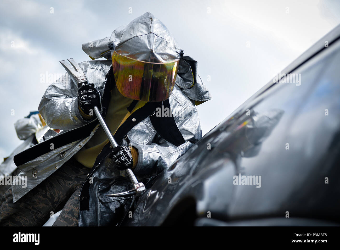 A firefighter from the 2nd Civil Engineer Squadron uses a halligan tool ...