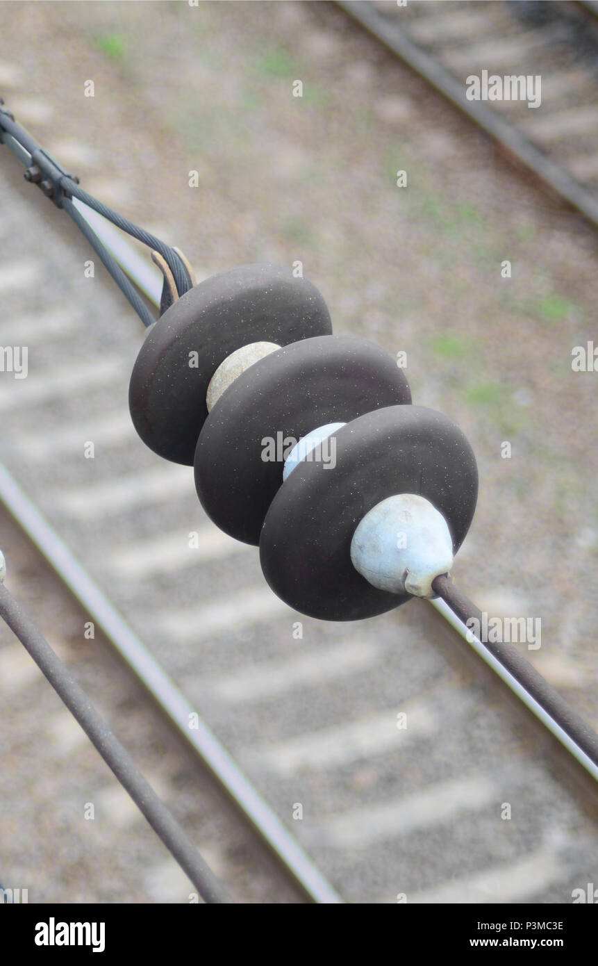 Electrical insulators on the contact wires on the background of a ...