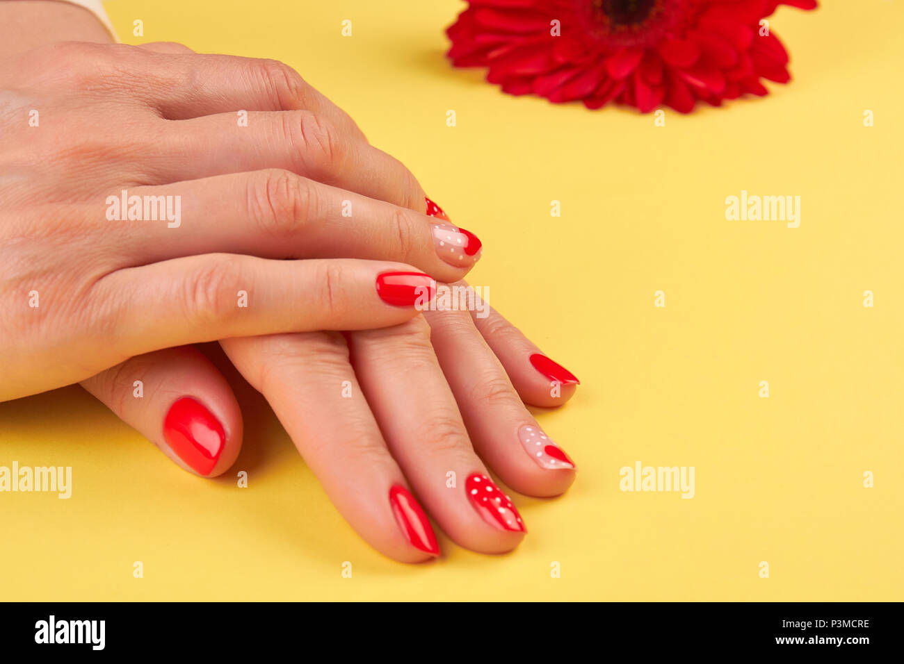 Manicured hands on yellow background Stock Photo - Alamy