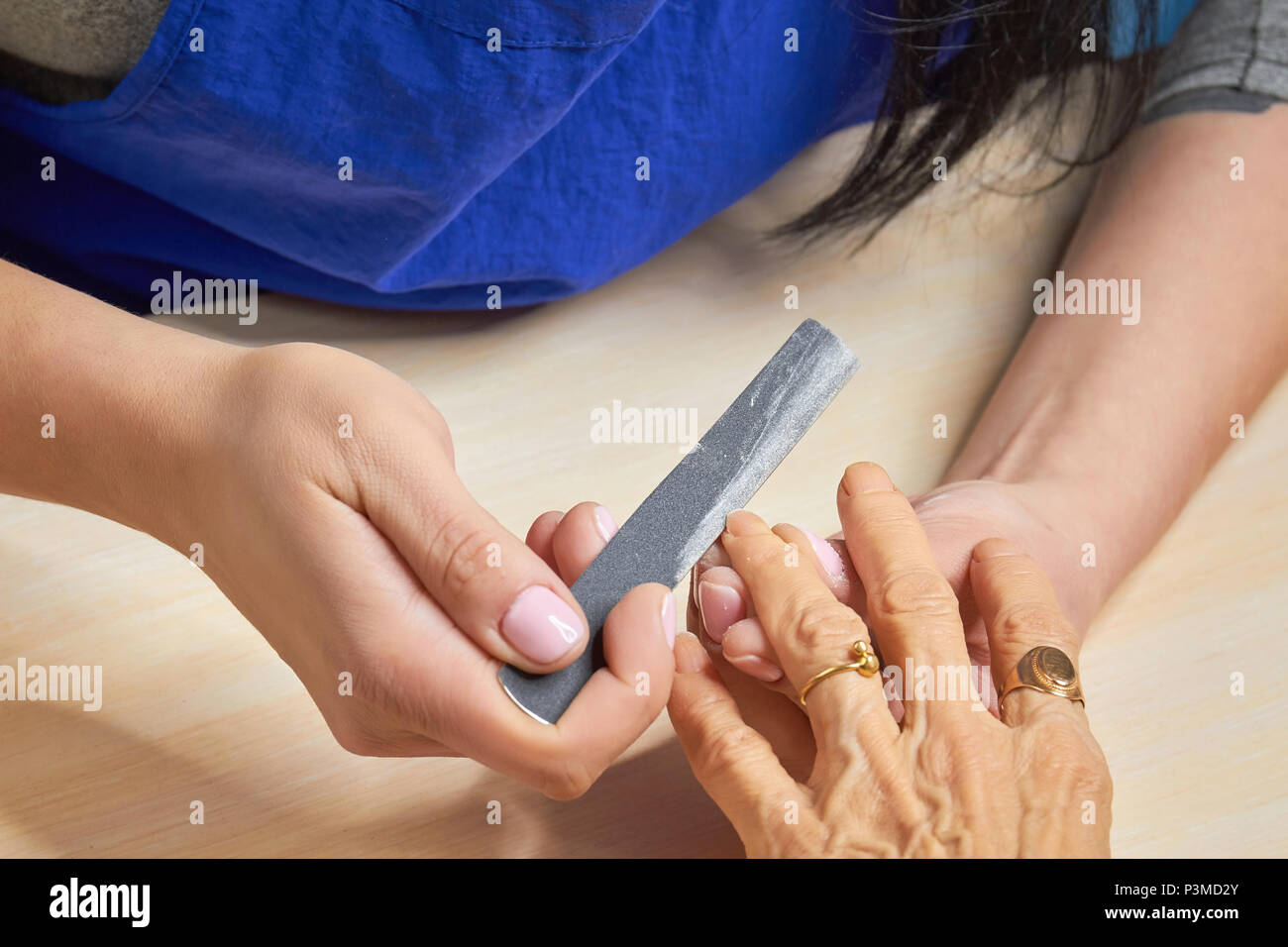 Woman file filing nails hi-res stock photography and images - Alamy