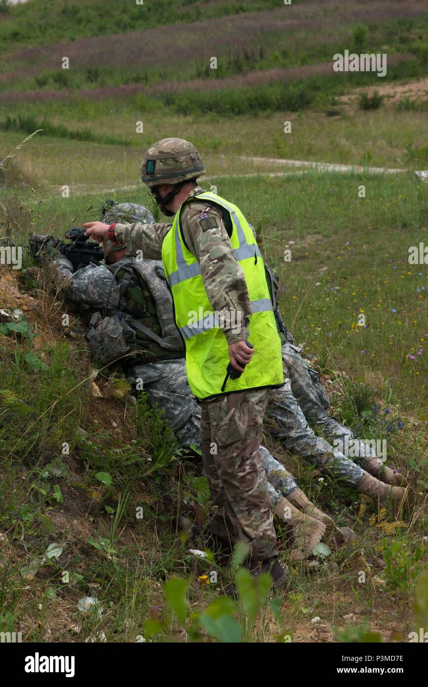 A U.S. Army West Point cadet is instructed by a British Observer, while ...