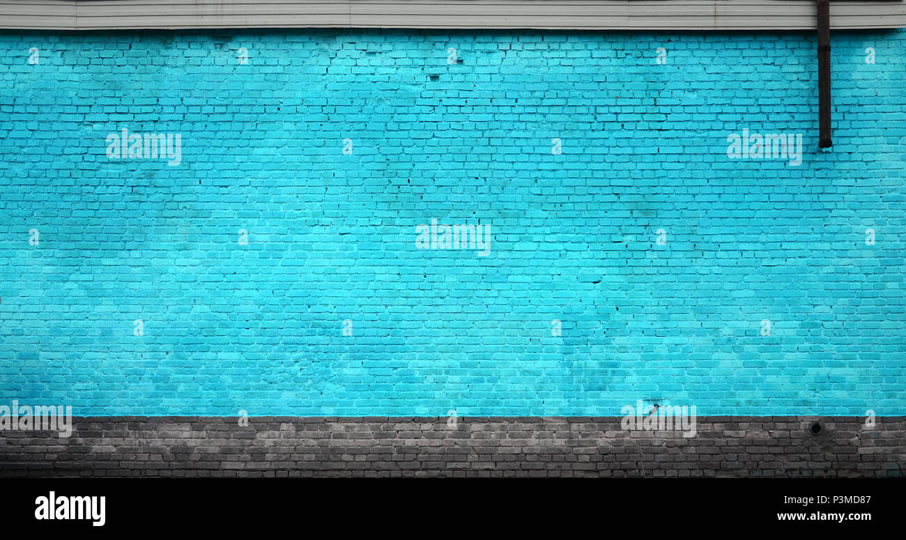 The texture of the brick wall of many rows of bricks painted in cyan ...