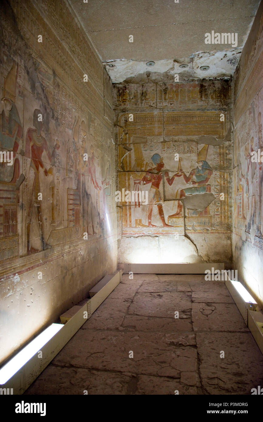 Colorfully painted bas relief carvings depict Pharaoh and the Egyptian ...