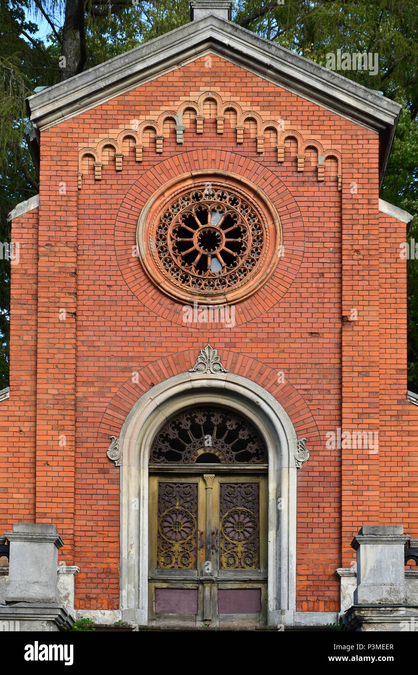 Texture front part of an ancient brick crypt with a round patterned ...