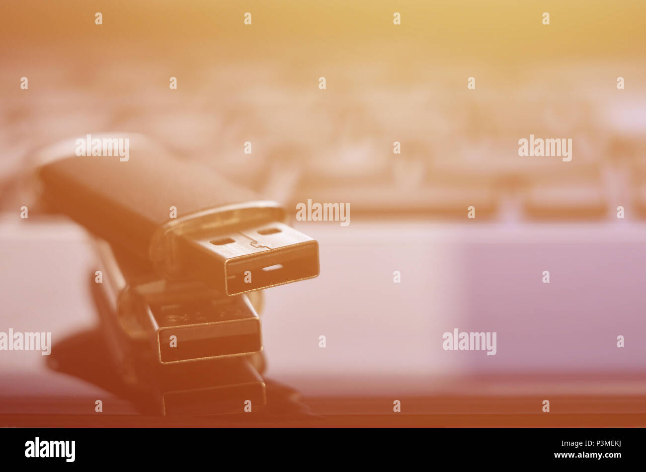 USB flash cards lying on black laptop case in front of his keyboard ...