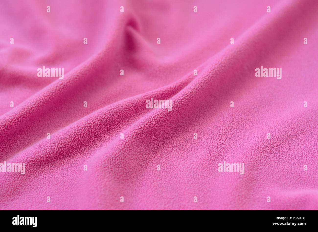 The blanket of furry pink fleece fabric. A background of light pink ...