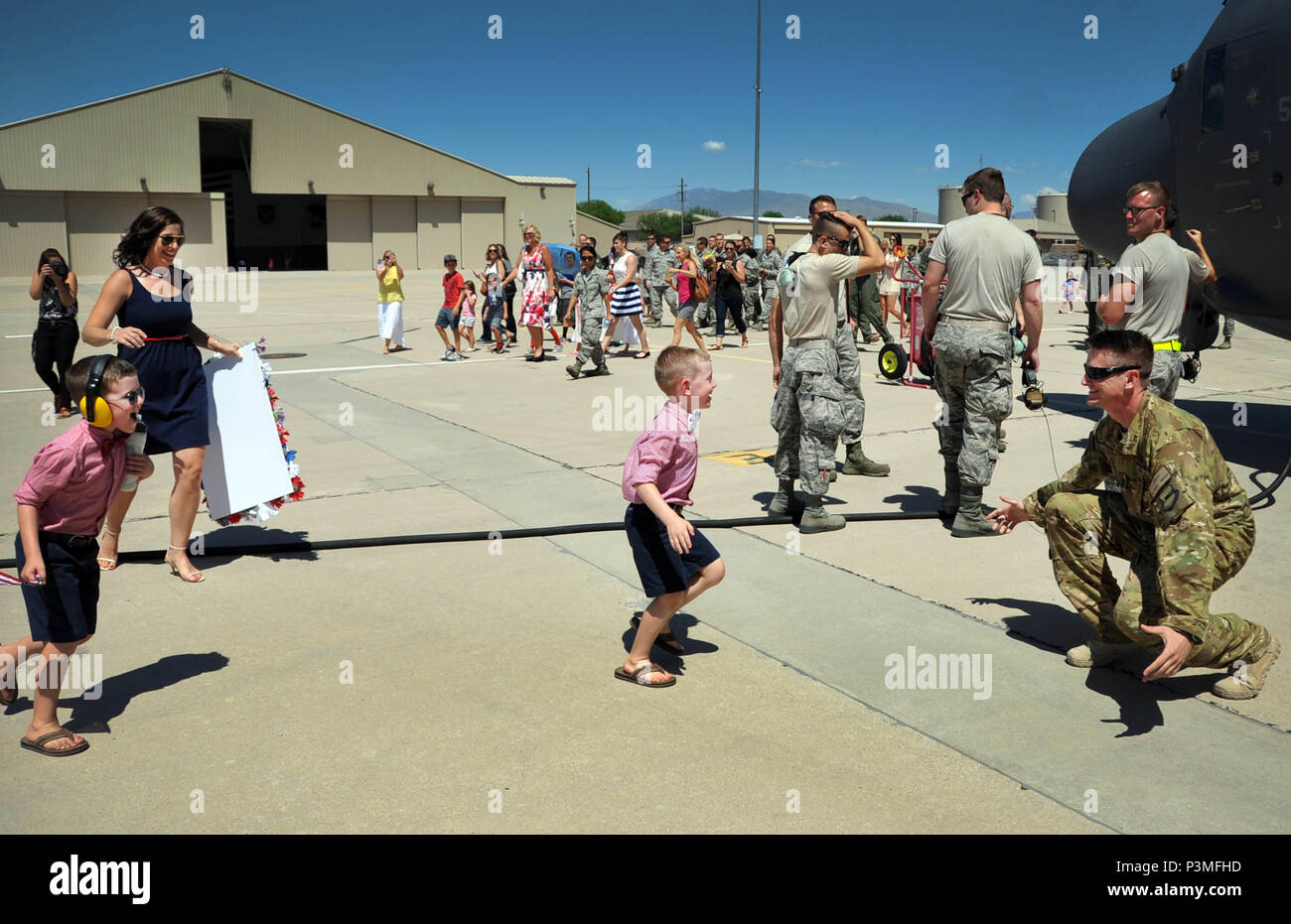 U.S. Air Force Maj. Brian Tripp, right, greets his sons, Jackson and ...
