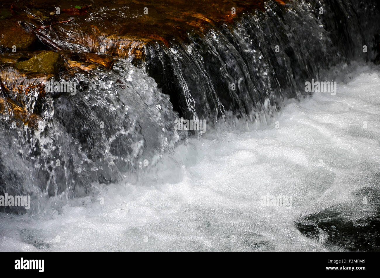 A small waterfall. The height difference of the water flow in the river ...