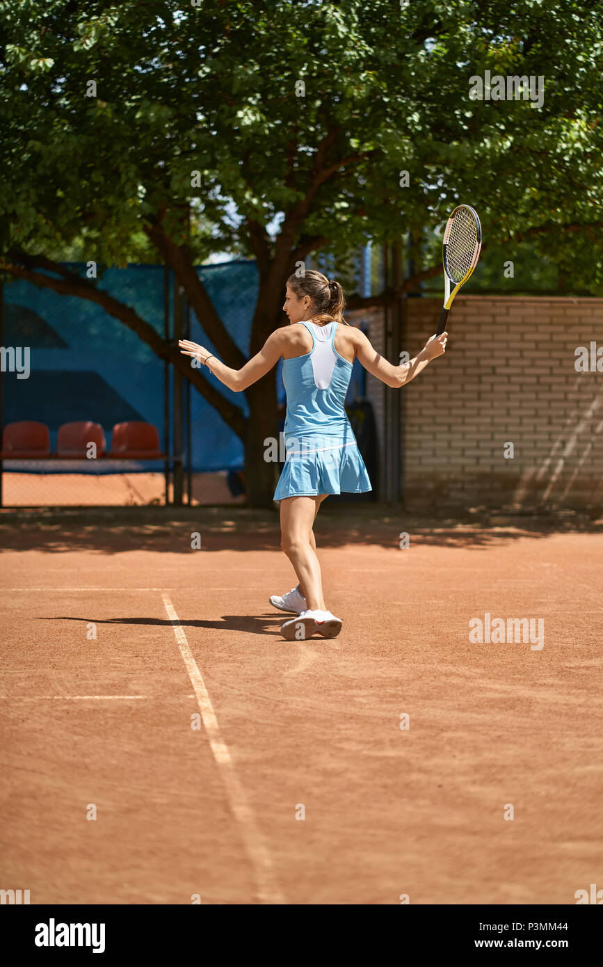 Sportive girl plays tennis Stock Photo - Alamy