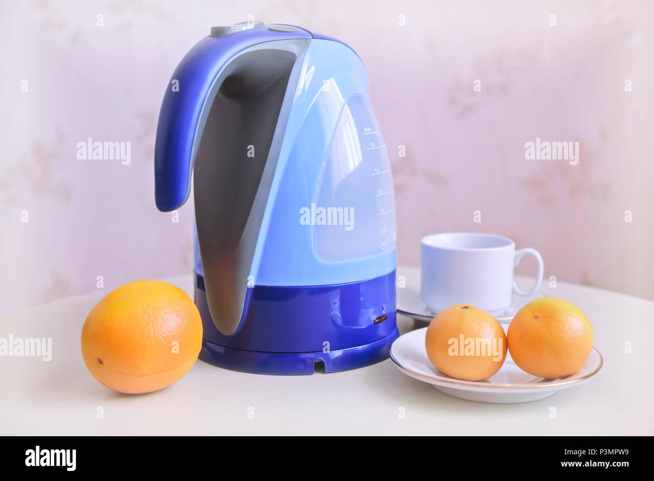 Electric kettle and fruit on the table Stock Photo - Alamy