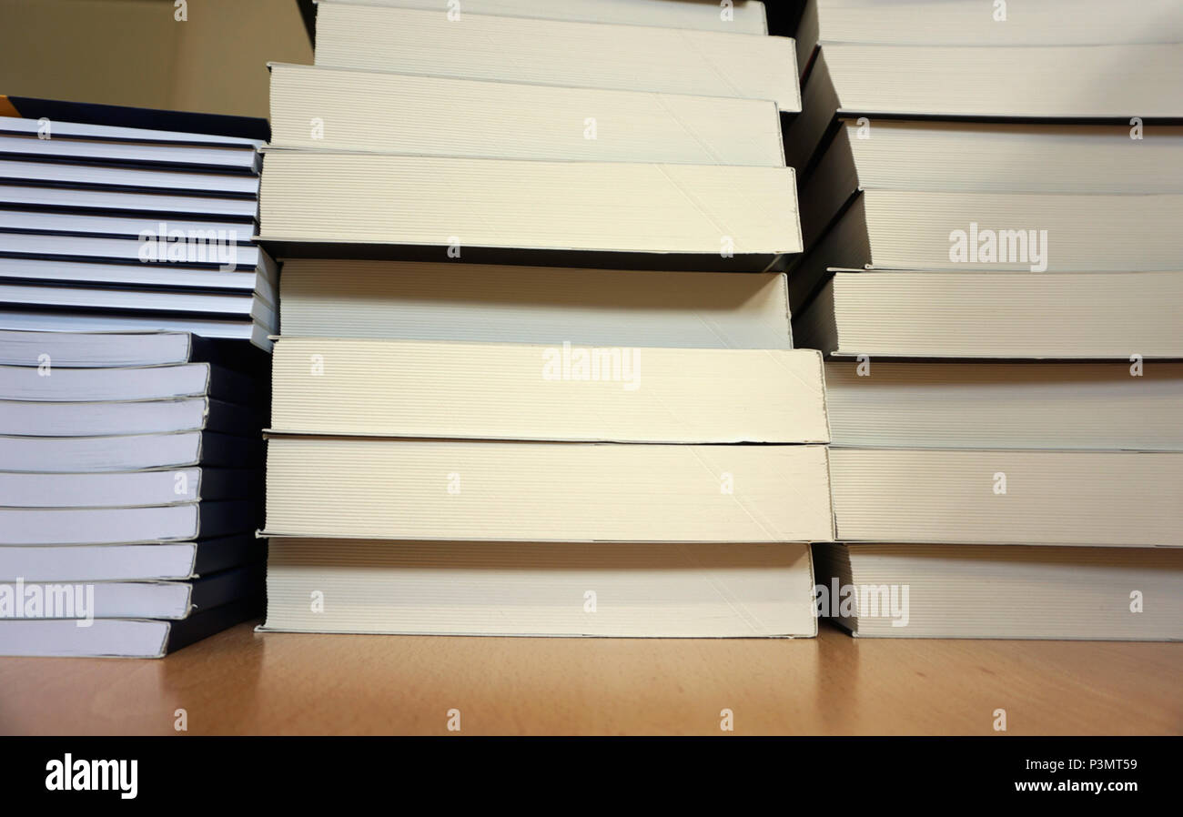 New books with white pages stack on the wooden table. Education ...