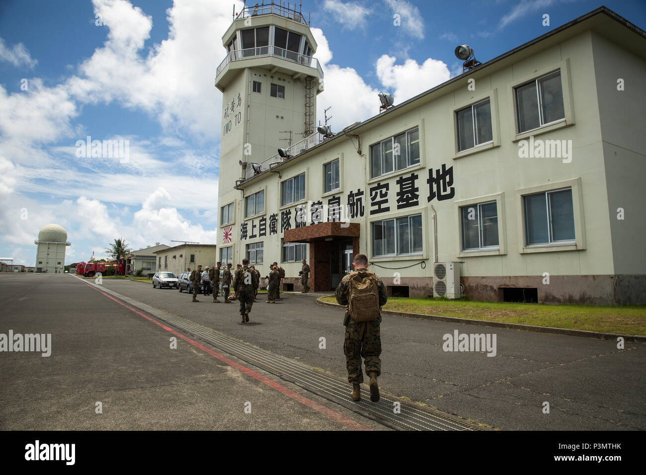 Marines and Sailors muster by the air traffic control tower on Iwo To ...