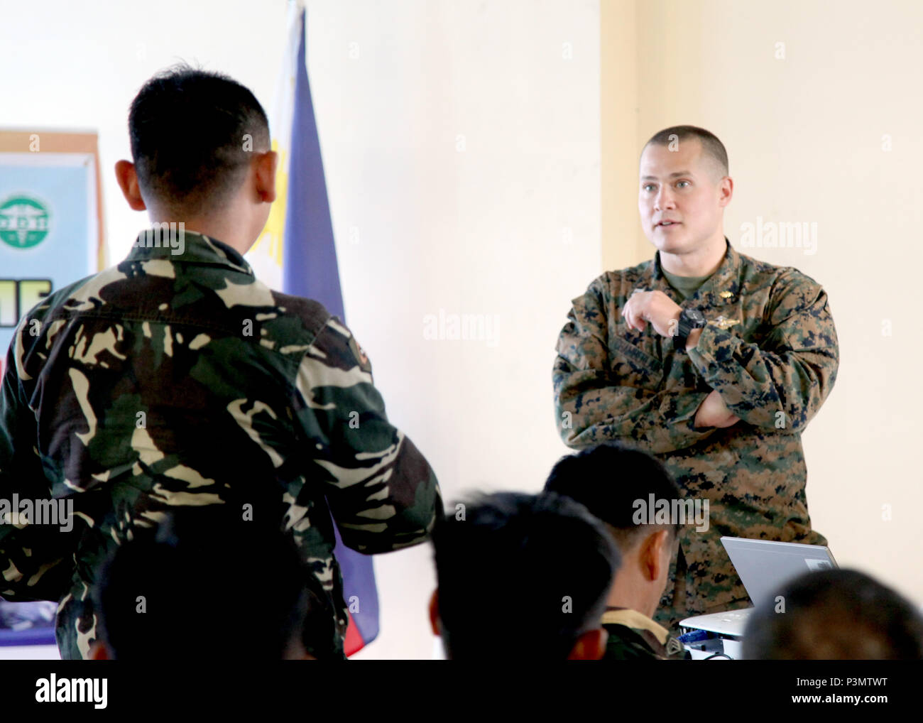 ORMOC, Philippines - U.S. Navy Lt. Derek Chamberlain answers a question from a member of the ...